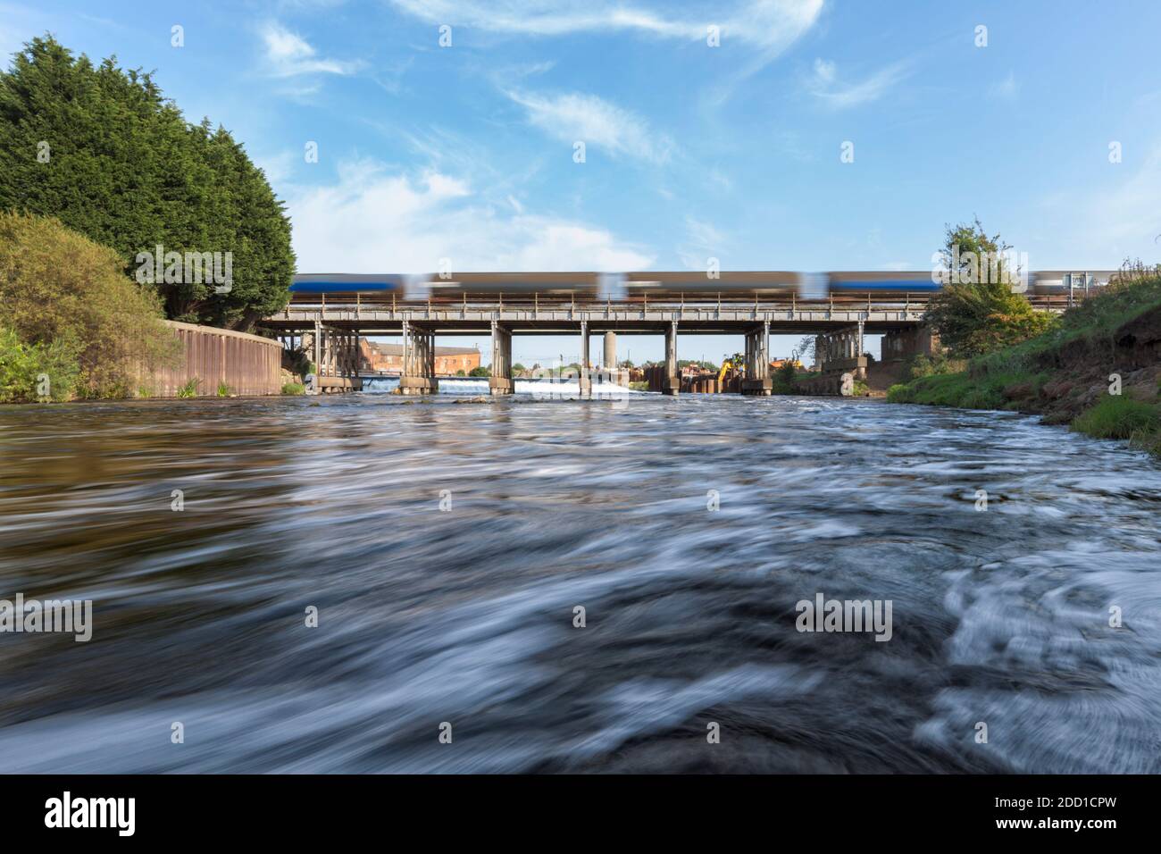DB cargo operated freight train of bogie oil tanks crossing the river ...