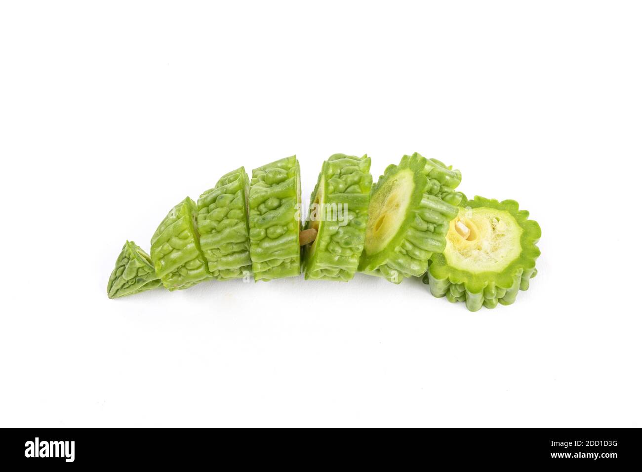 A vertical shot of sliced bitter gourd isolated on a white background ...