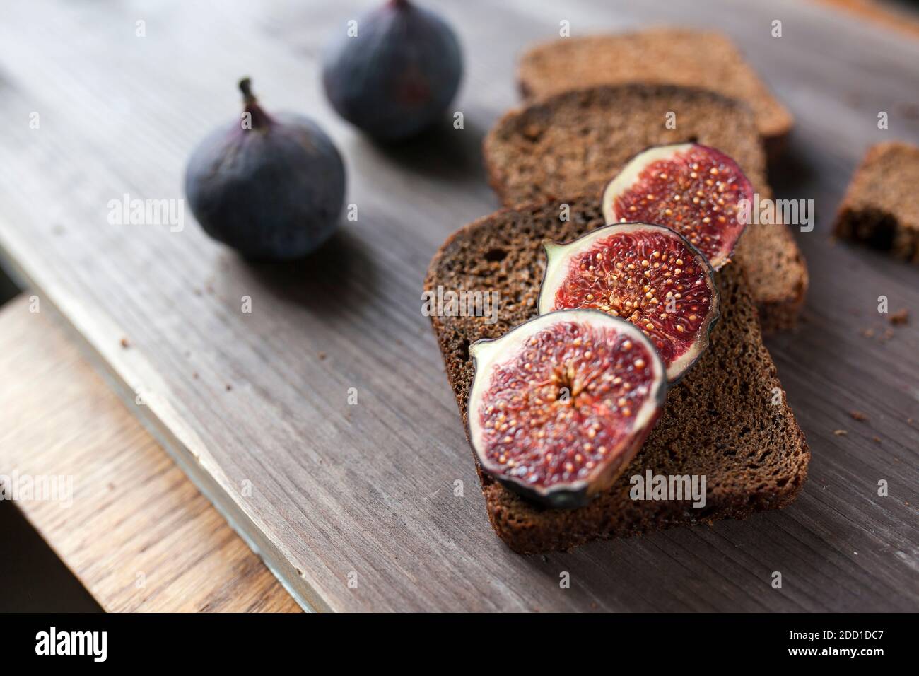 Bunch of fresh ripe figs on wodden brown background. Tropical fruit ...