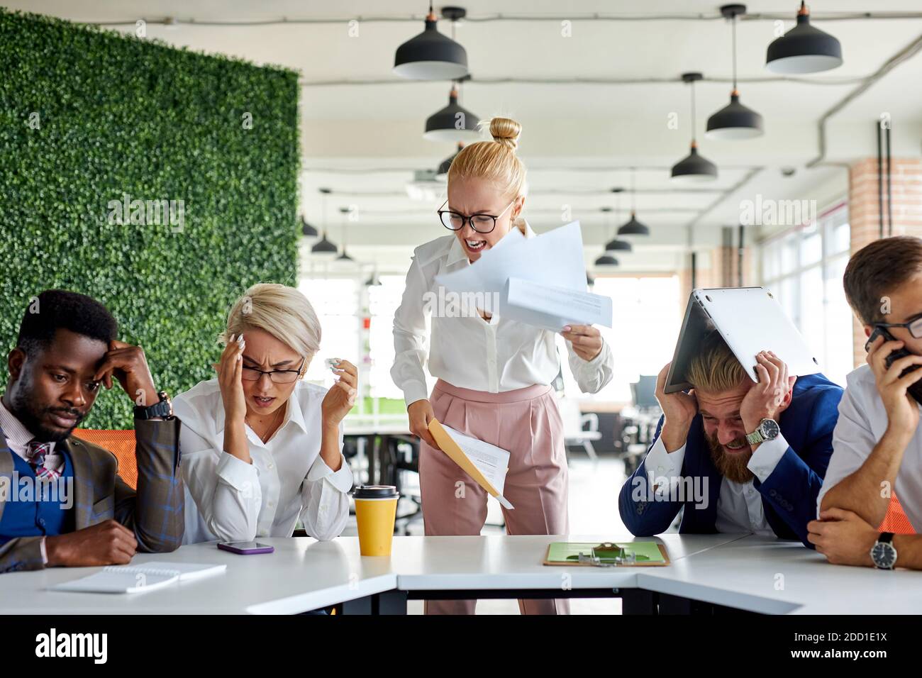 team of sad frustrated employees receiving rebuke by shouting female ...