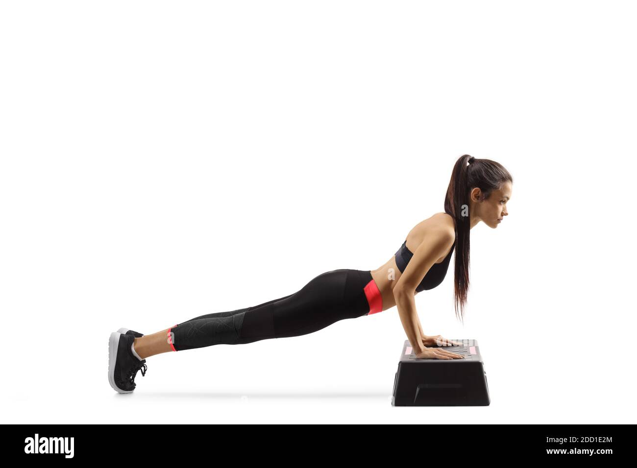 Slim sporty female doing push-ups on a stepper isolated on white ...