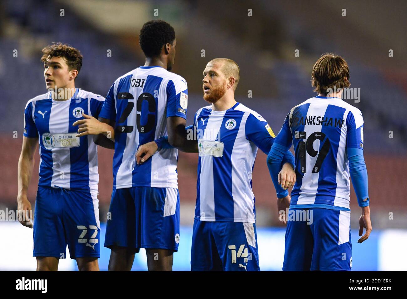 Joe Garner #14 of Wigan Athletic organises the defensive wall in ...