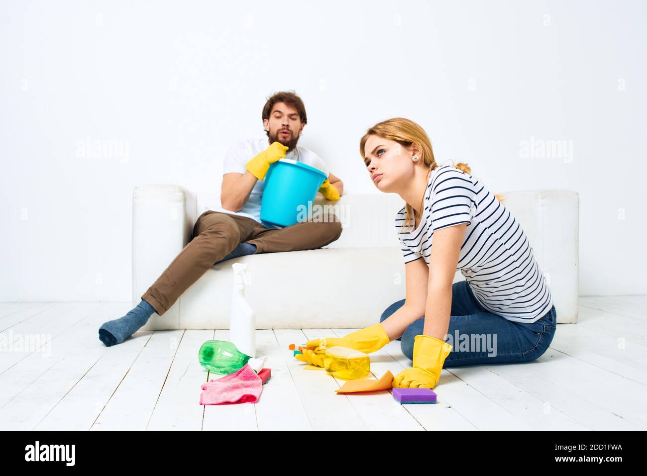 Man and woman home detergent cleaning together interior Stock Photo - Alamy