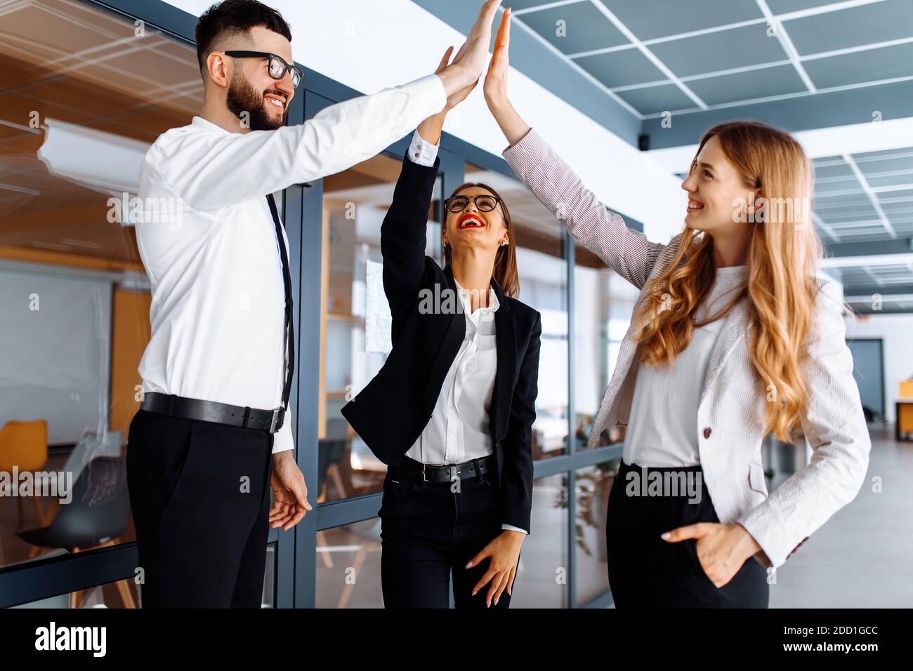 successful business team celebrating a victory by folding their hands ...