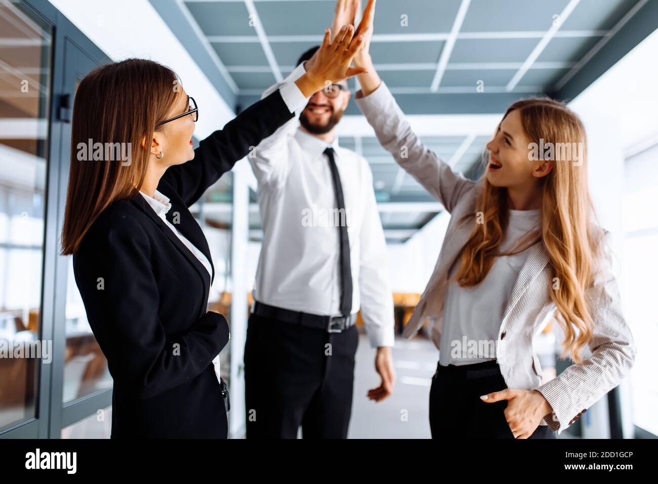 successful business team celebrating a victory by folding their hands ...