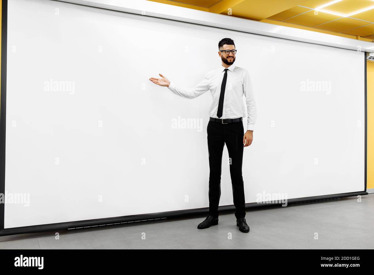 business man showing diagram on flyboard to creative team in office in ...