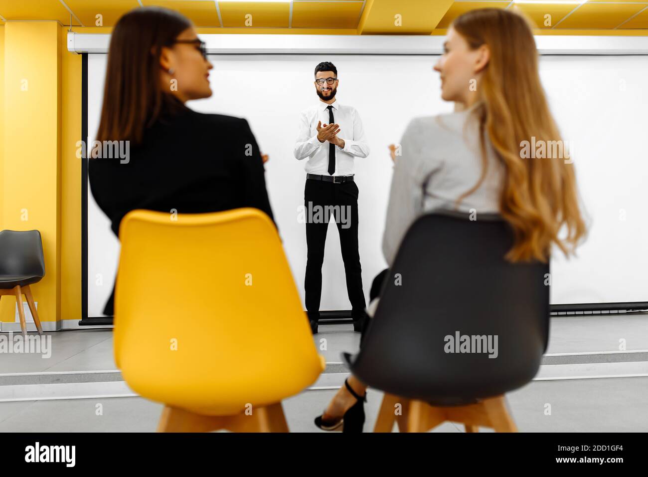 business man showing diagram on flyboard to creative team in office in ...