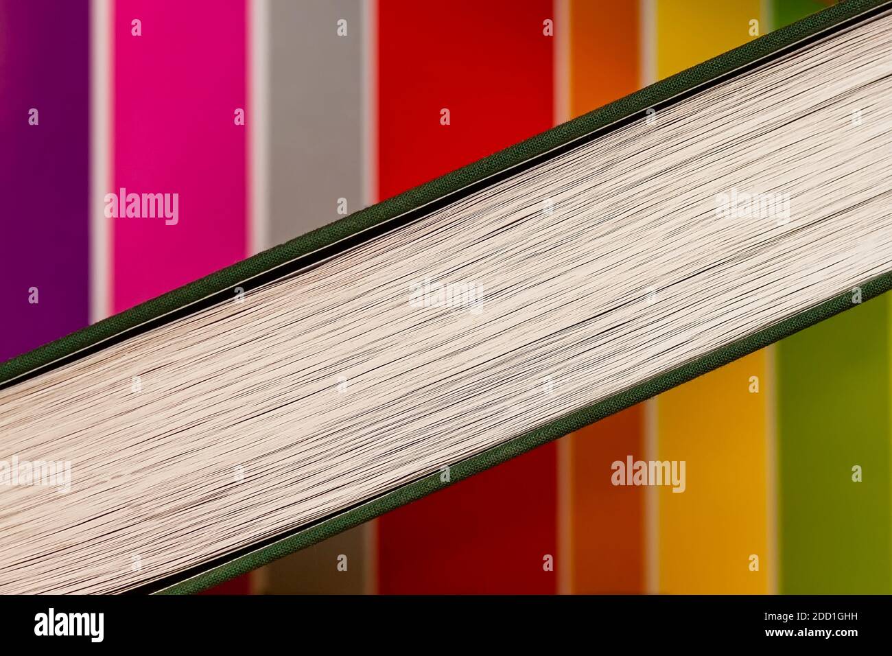 Closed book on background with stripes of different colors, top view ...