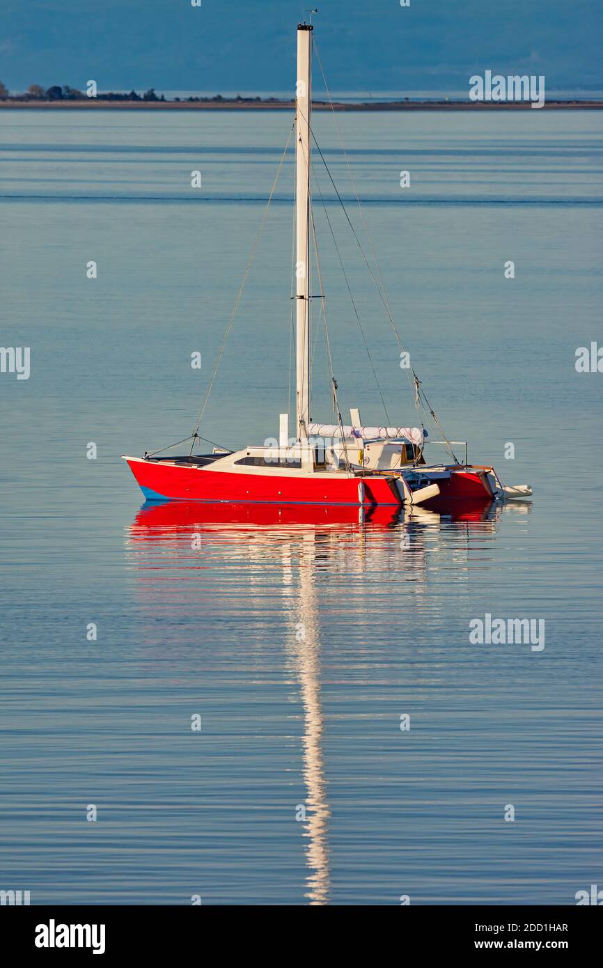 Red catamaran sailboat in Vancouver Island, BC, Canada Stock Photo - Alamy