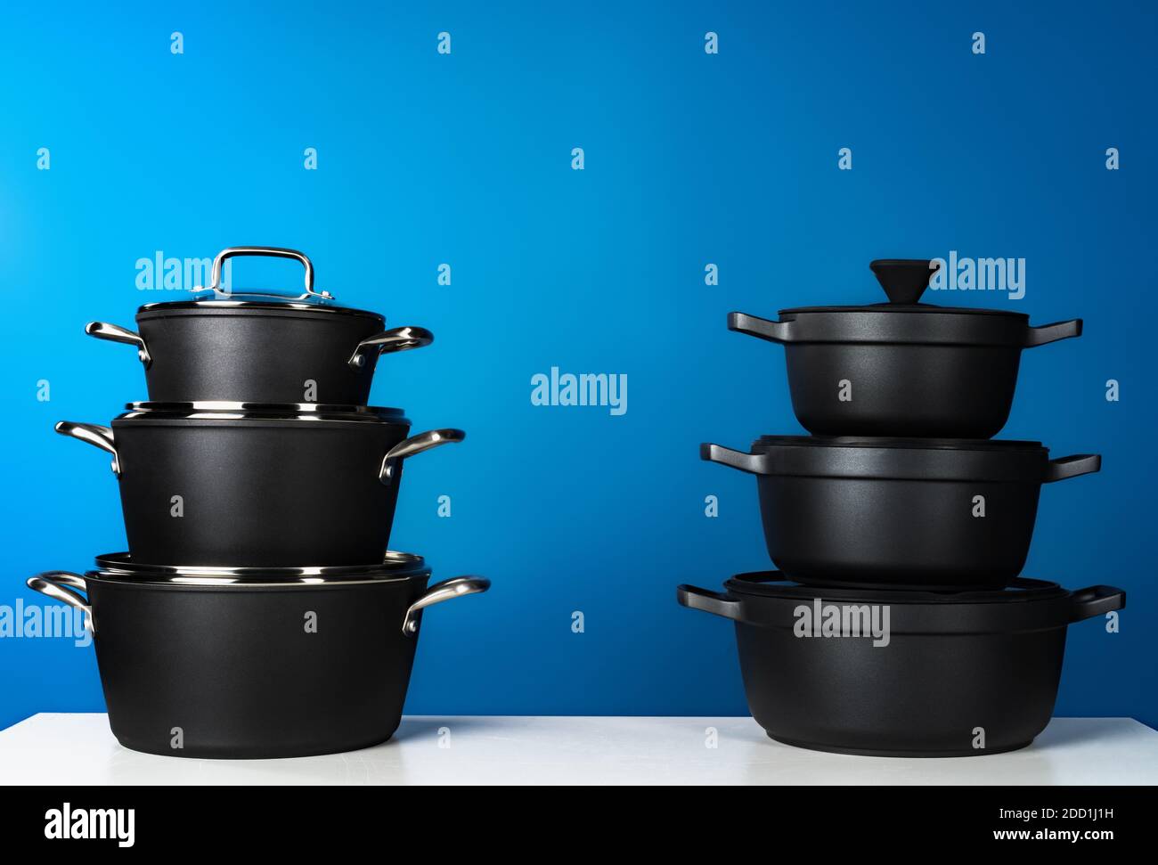 Set of black cookware against blue background Stock Photo - Alamy