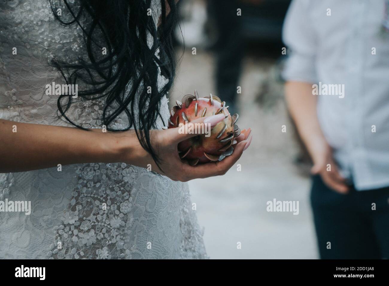 an apple with a lot of coins in the hand of a woman Stock Photo - Alamy