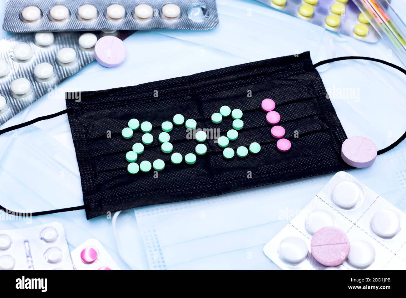 2021 layout of blue and pink pills on black mask background, flatlay ...