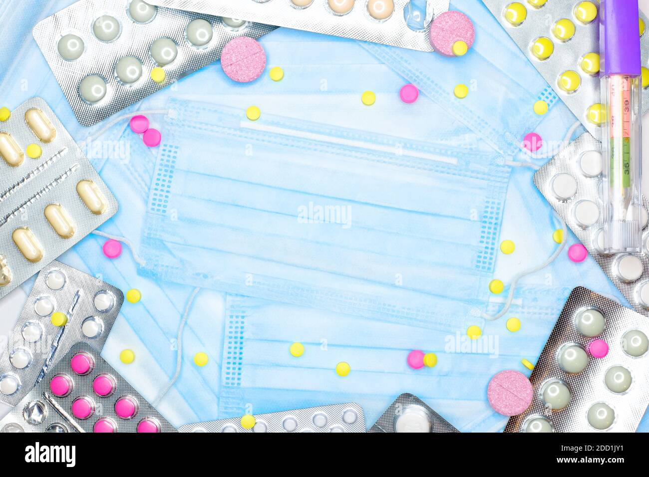 Medical layout with scattered pills, thermometer and masks, copyspace ...
