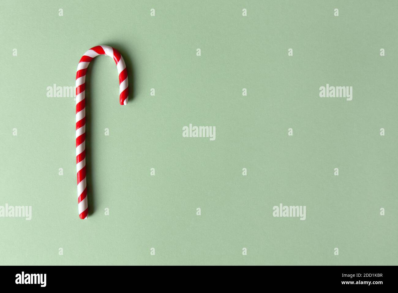Christmas peppermint candy cane on olive green background. Festive ...