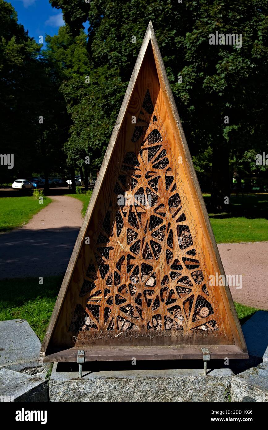 Large triangular insect hotel made from wood and branches Stock Photo ...