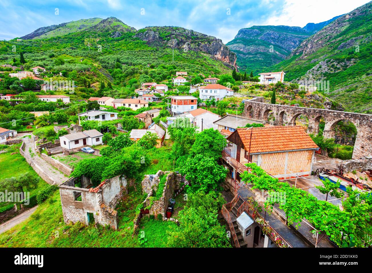 Medieval aqueduct ruins and local houses in the Stari Grad Bar or Bar ...