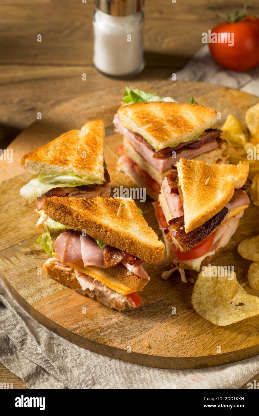 Homemade Turkey Club Sandwich with Bacon Ham and Tomato Stock Photo - Alamy