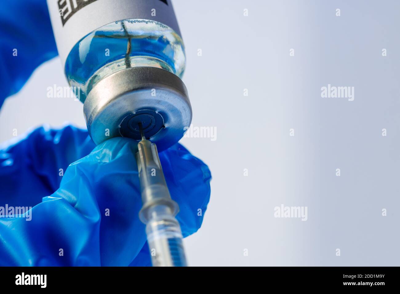 Doctor hands holding glass vial with medication Stock Photo - Alamy