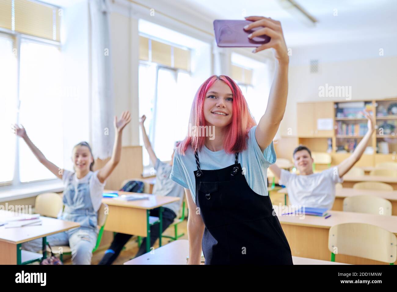 Teenagers students having fun in the classroom Stock Photo - Alamy