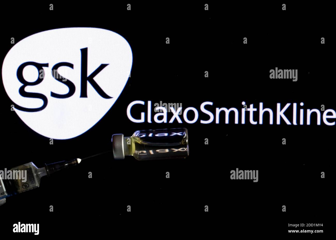 In this photo illustration a medical syringe with a bottle of liquid ...