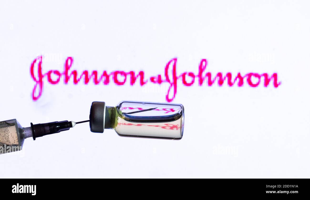 In this photo illustration a medical syringe with a bottle of liquid ...