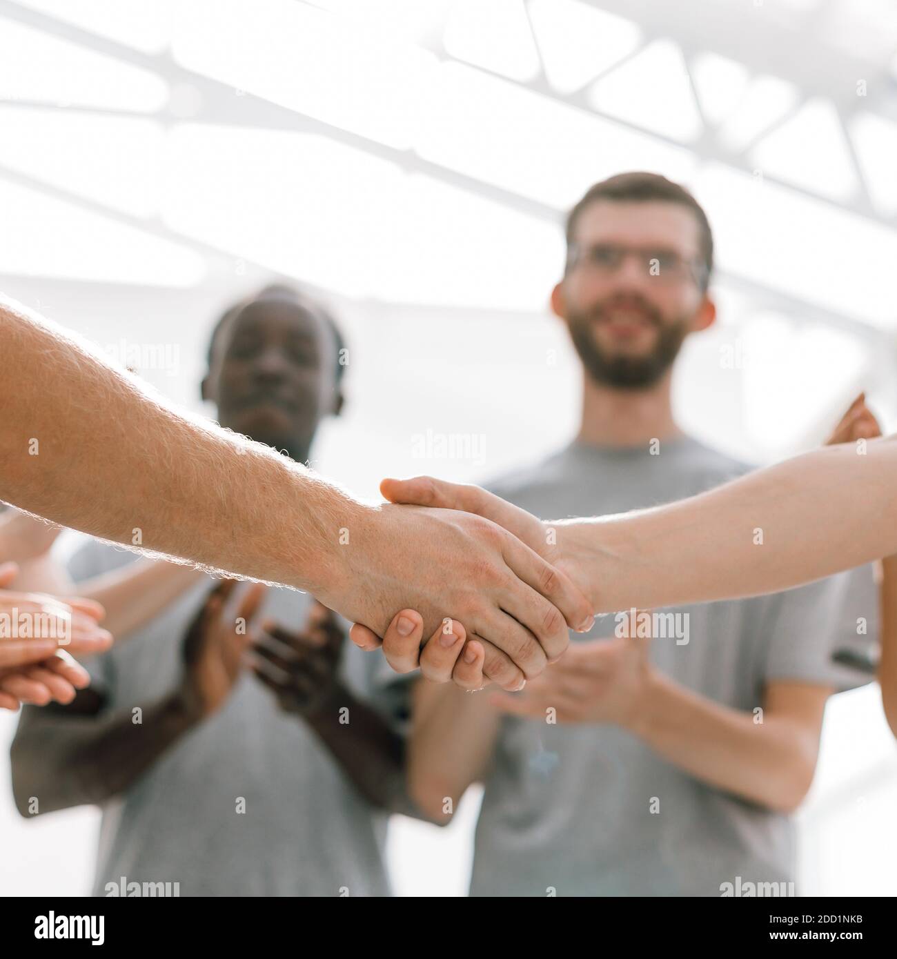 close up. handshake of two students on the background of the st Stock ...