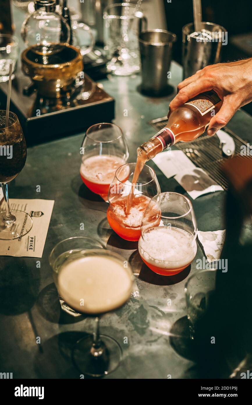 Bartender making an alcoholic cocktail, a summer cocktail in the bar ...