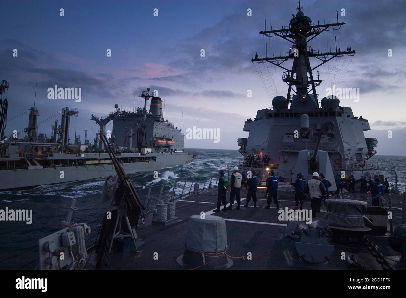 As night falls USS Roosevelt carrys out an Underway Replenishment ...