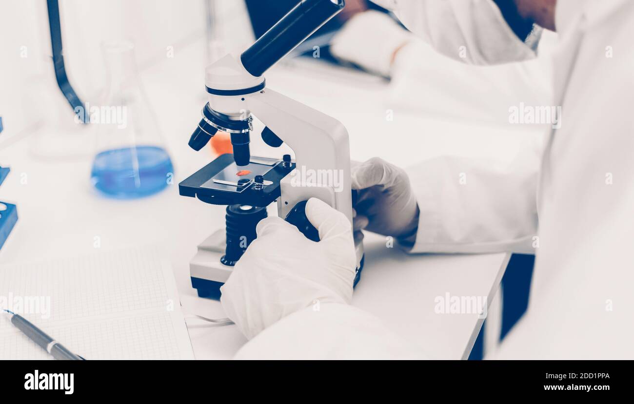 close up. image of a scientist looking through a microscope Stock Photo ...
