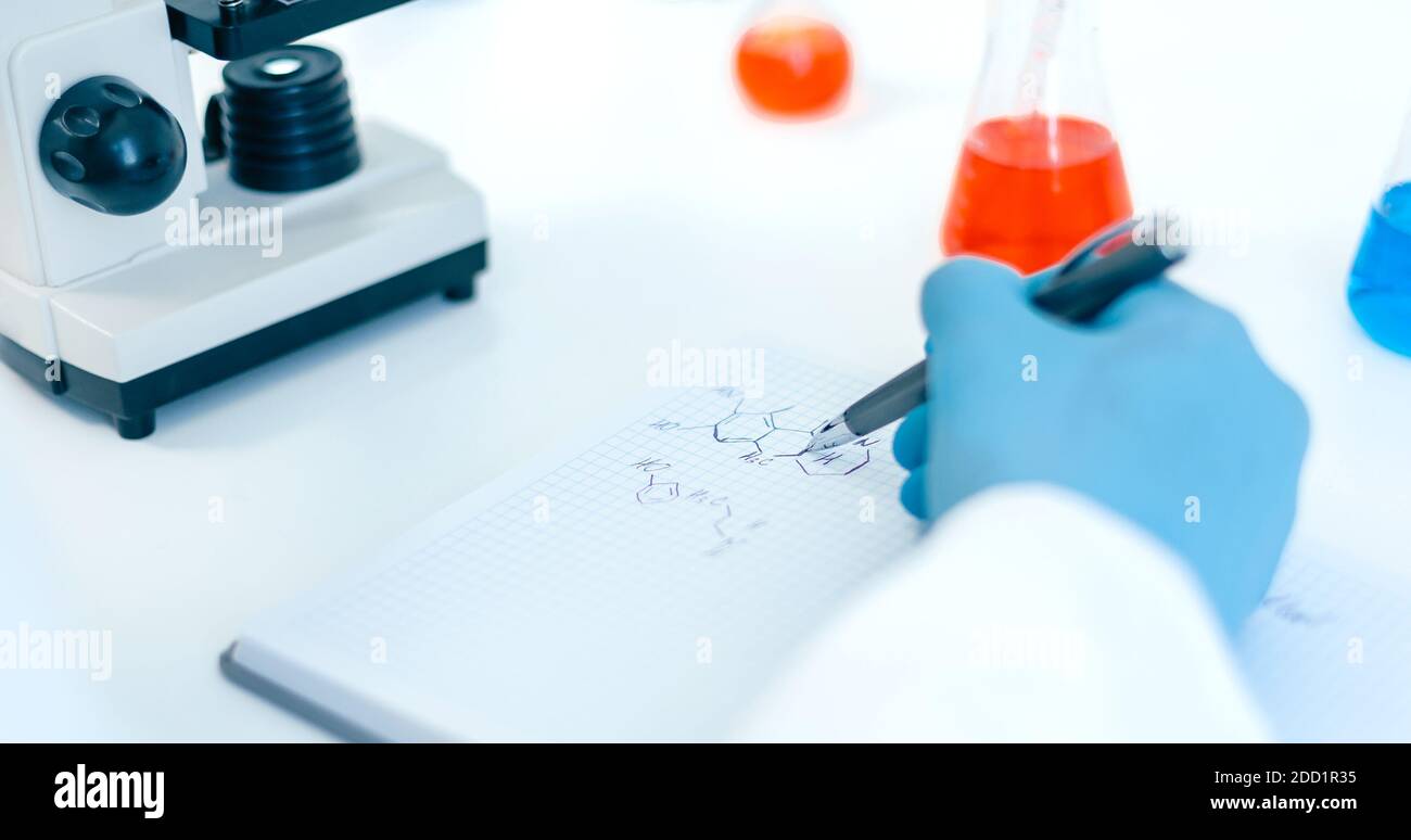 close up. scientist looking at a drop of blood through a microscope ...