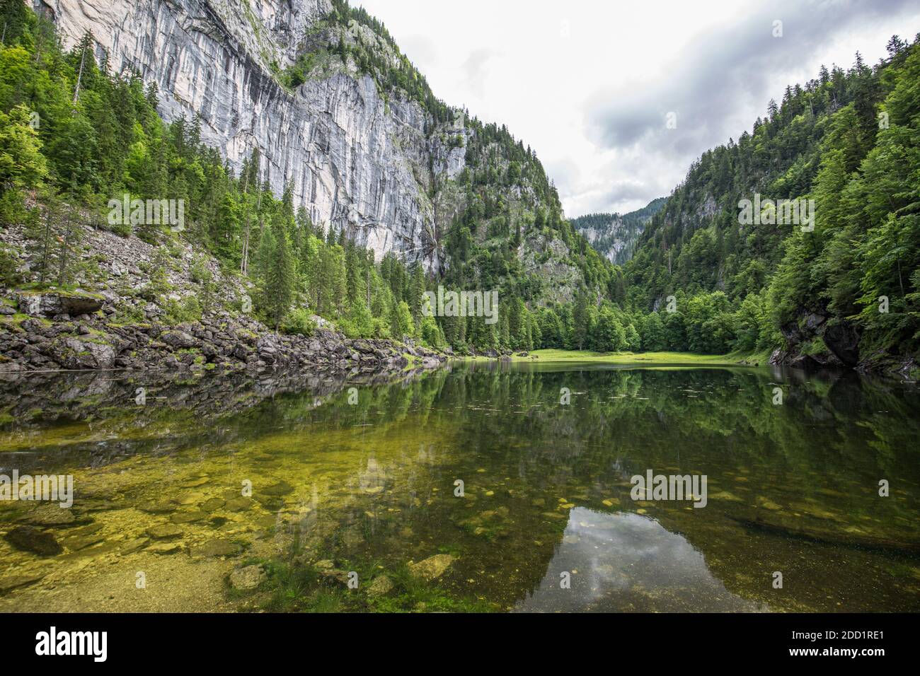 Idyllic summer landscape with clear mountain lake in the Alps, cloudy ...