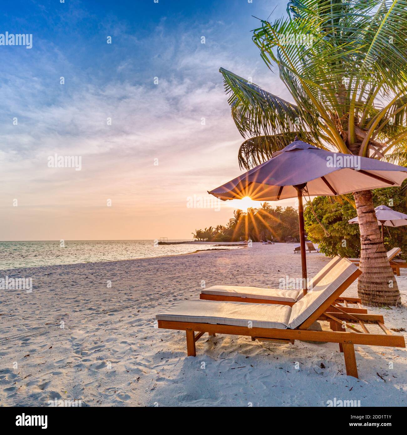 Beautiful sunset relax beach. Chairs on sandy beach near the sea ...