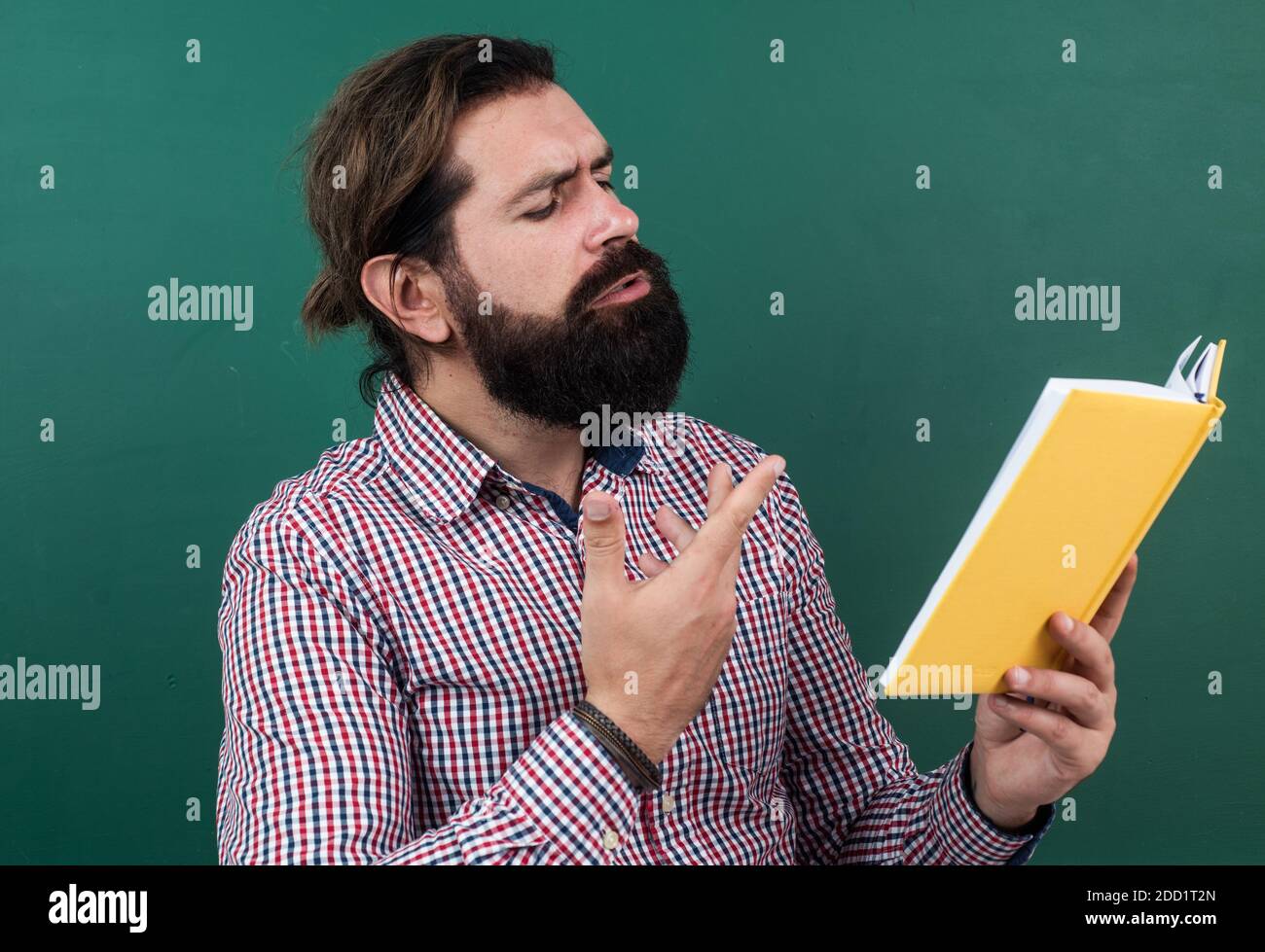 reading the poem. poetic man with beard reading the book. process of ...