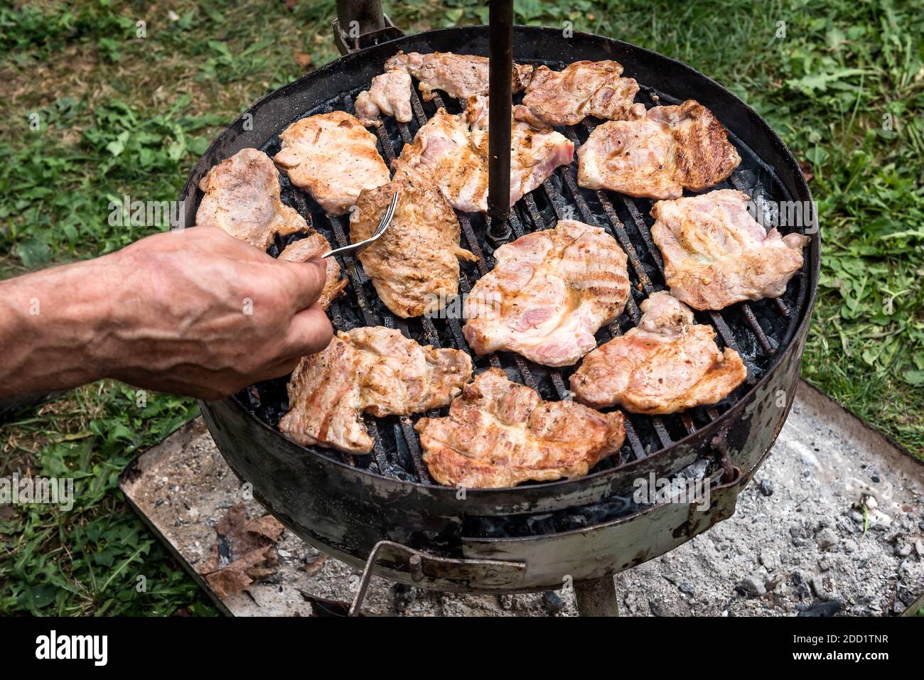 Kettle Charcoal BBQ Barbecue Grill in garden or backyard. Side View of ...