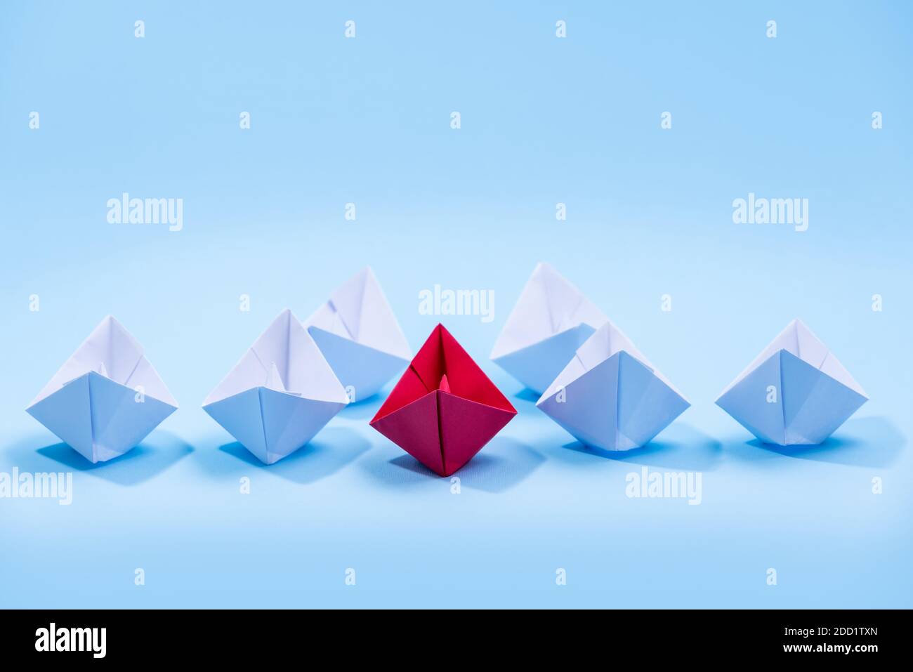Red and white paper boats. Concept of leadership boats for teamwork ...