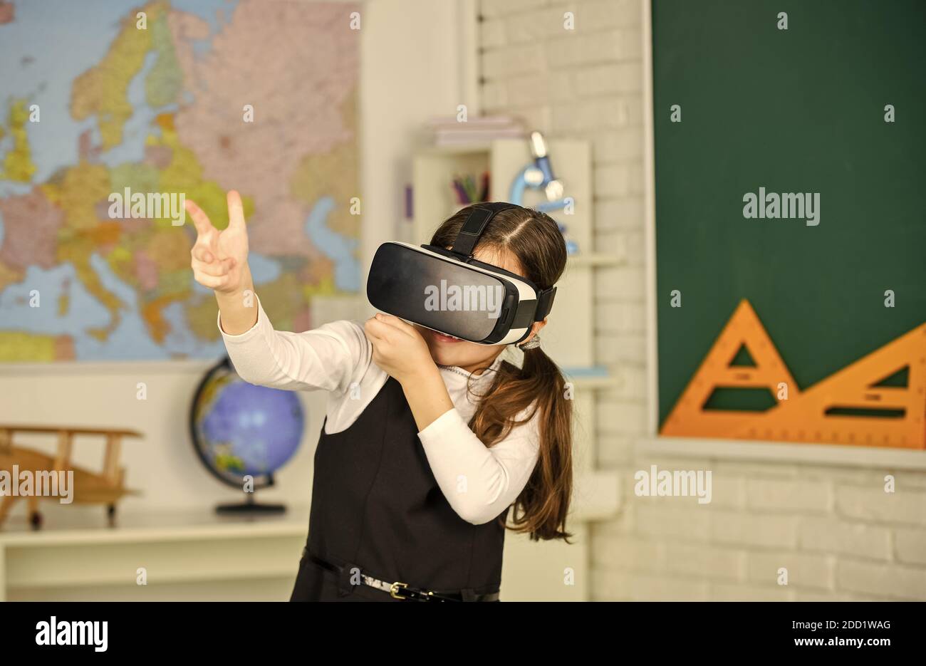 Headshot kills. Virtual classes. VR technology. schoolgirl using ...