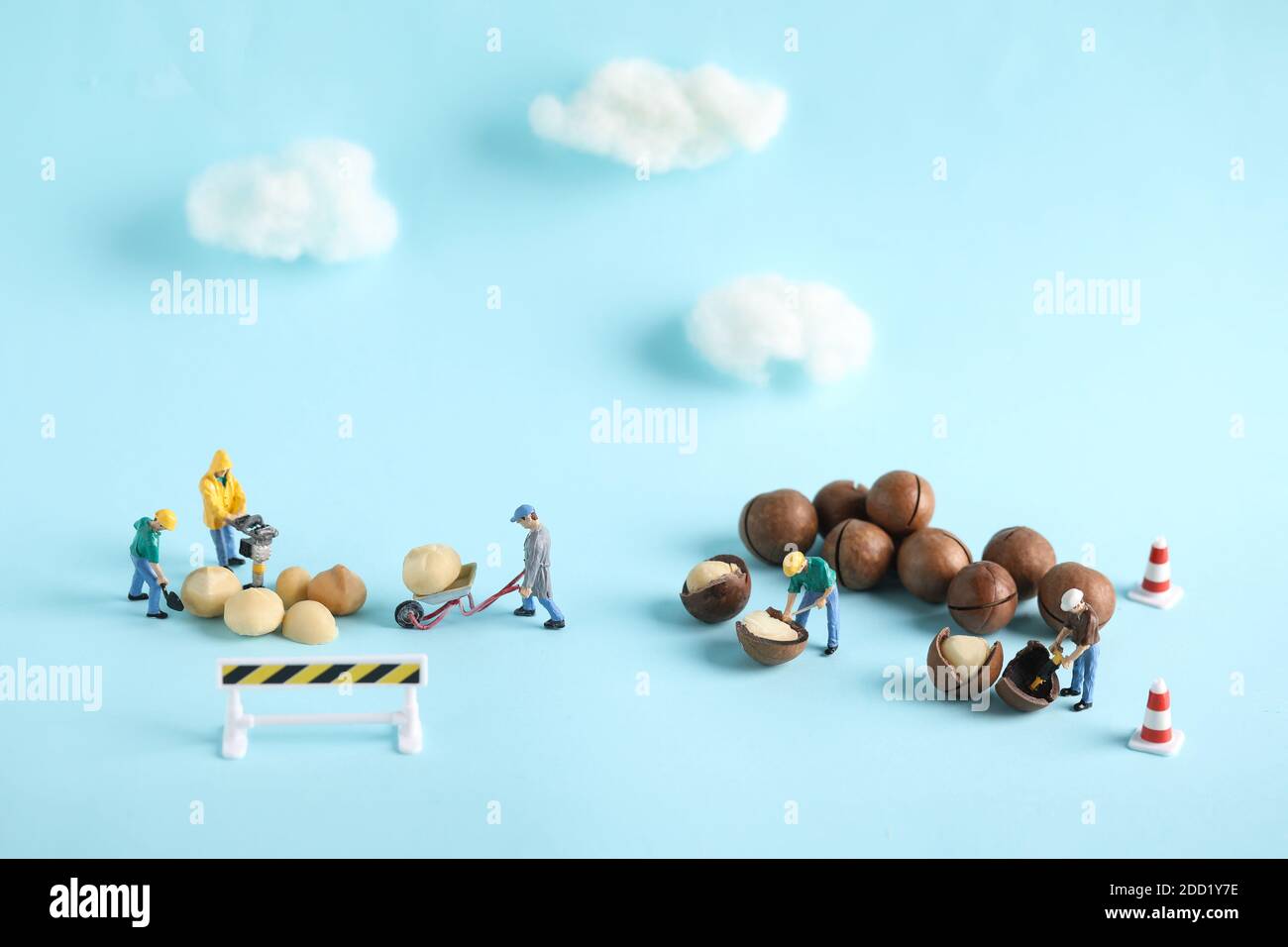 A closeup shot of small construction workers working on nuts Stock ...