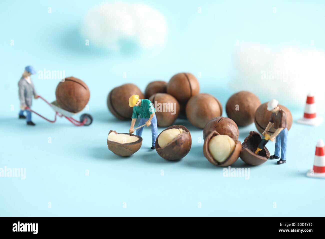 A closeup shot of small construction workers working on nuts Stock ...