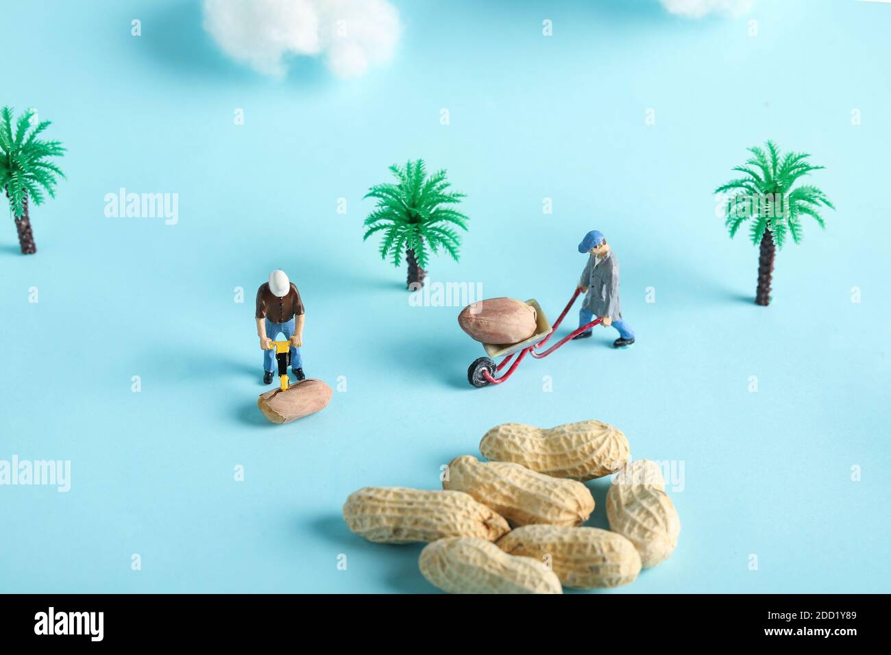 A closeup shot of small construction workers working on nuts Stock ...