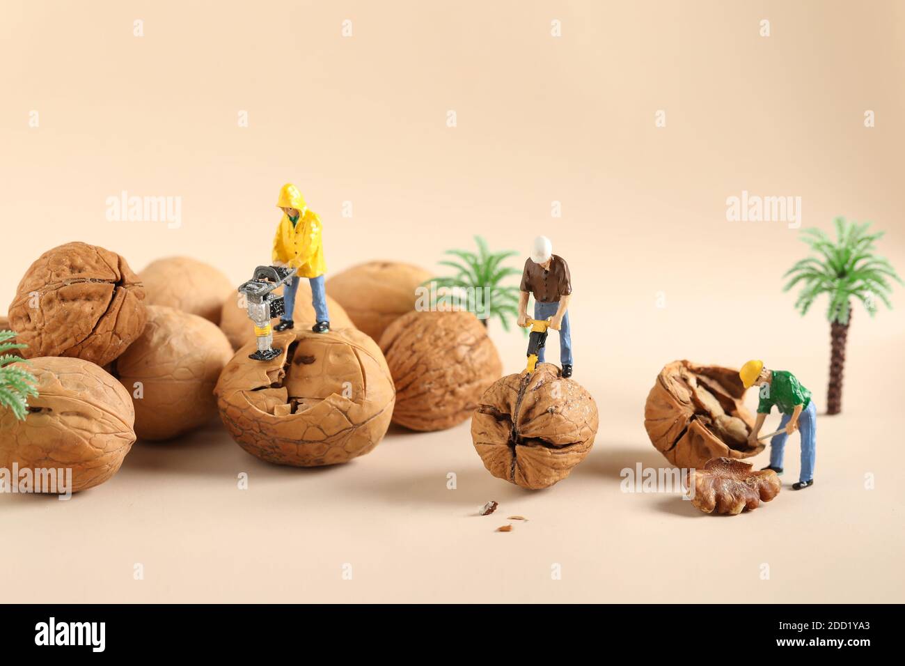 A closeup shot of small construction workers working on nuts Stock ...