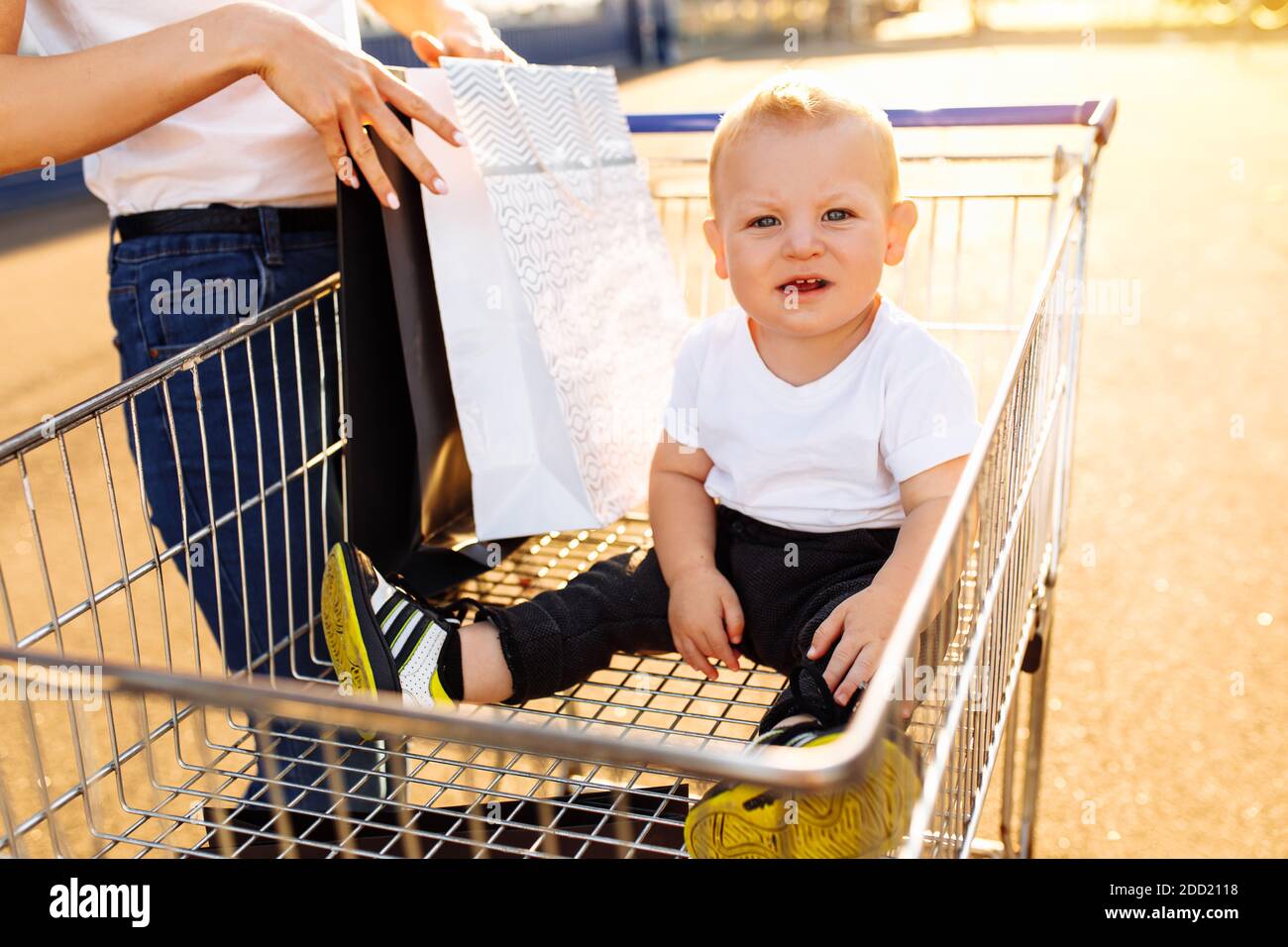 Happy little kid sitting in shopping cart, family shopping Stock Photo ...