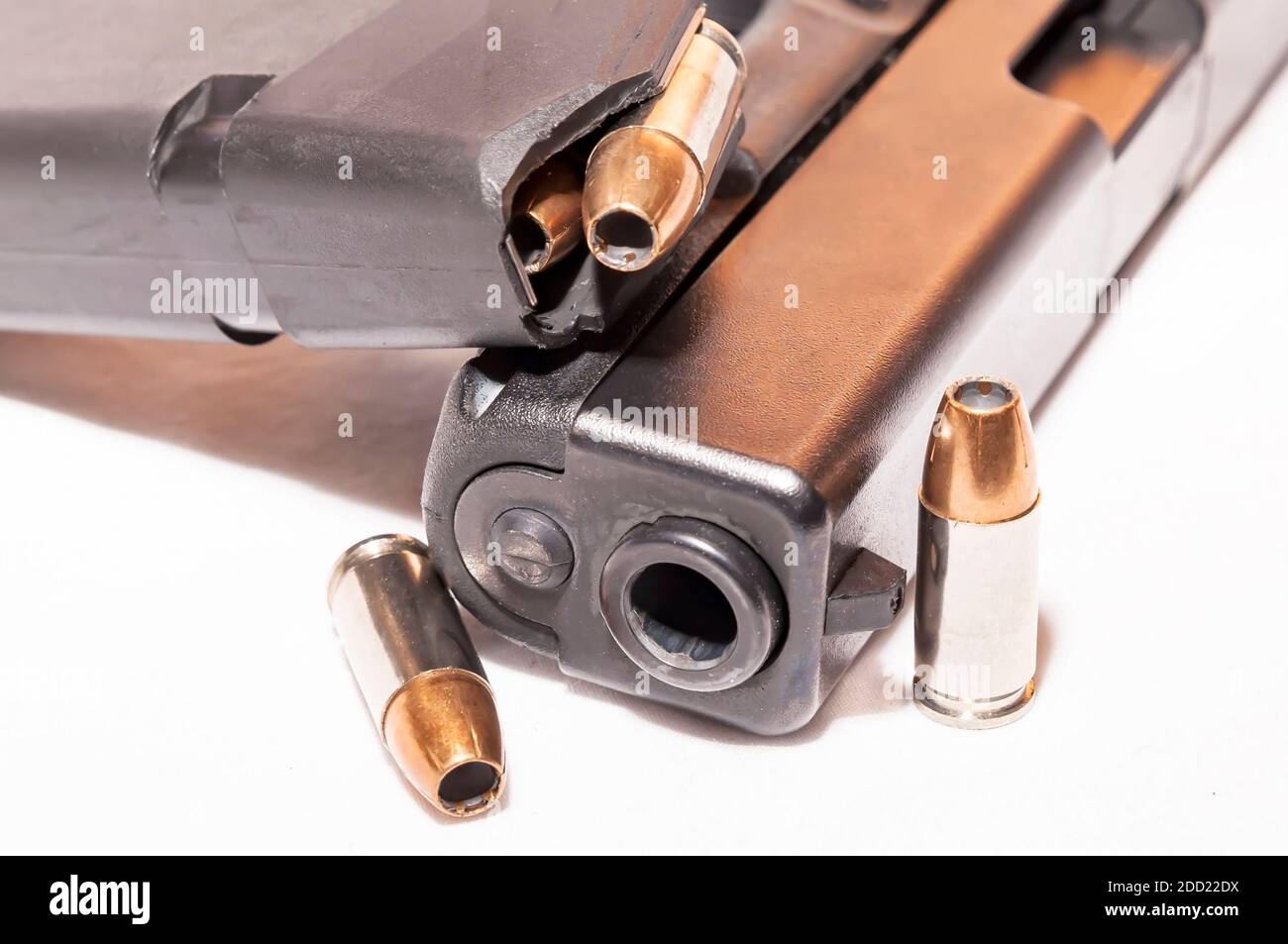 A black 9mm pistol with a magazine loaded with hollow point bullets and ...