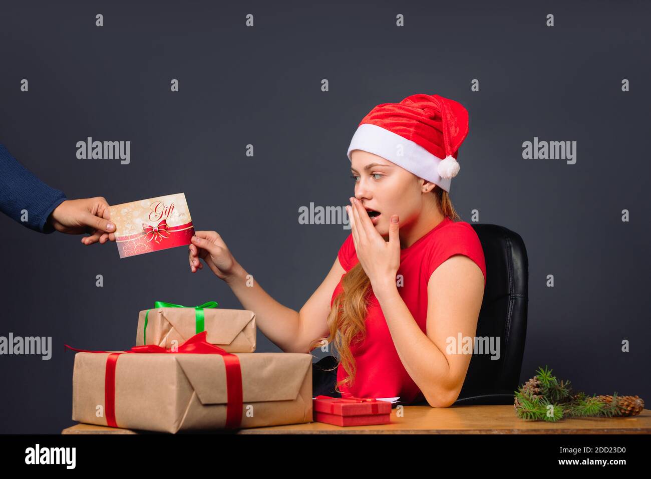 Surprised girl elf receives a postcard while sitting at a table with ...