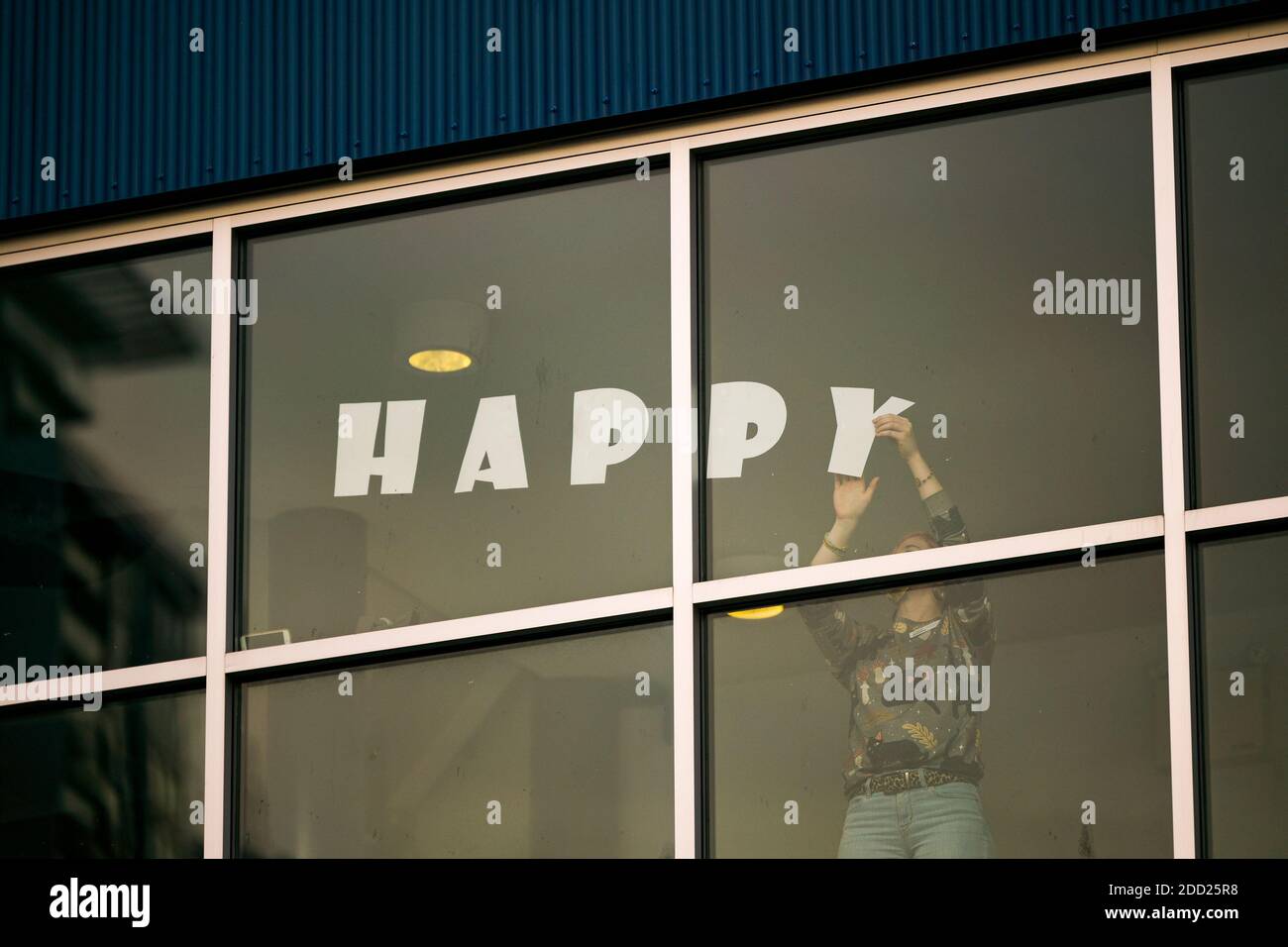 Woman putting up sign hi-res stock photography and images - Alamy