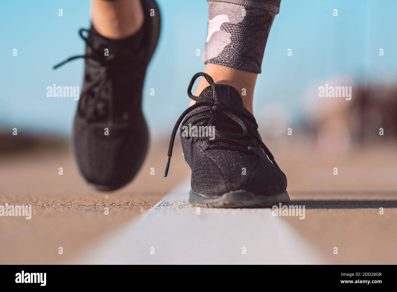 Runner feet running on road closeup on black shoe. Fitness, workout ...