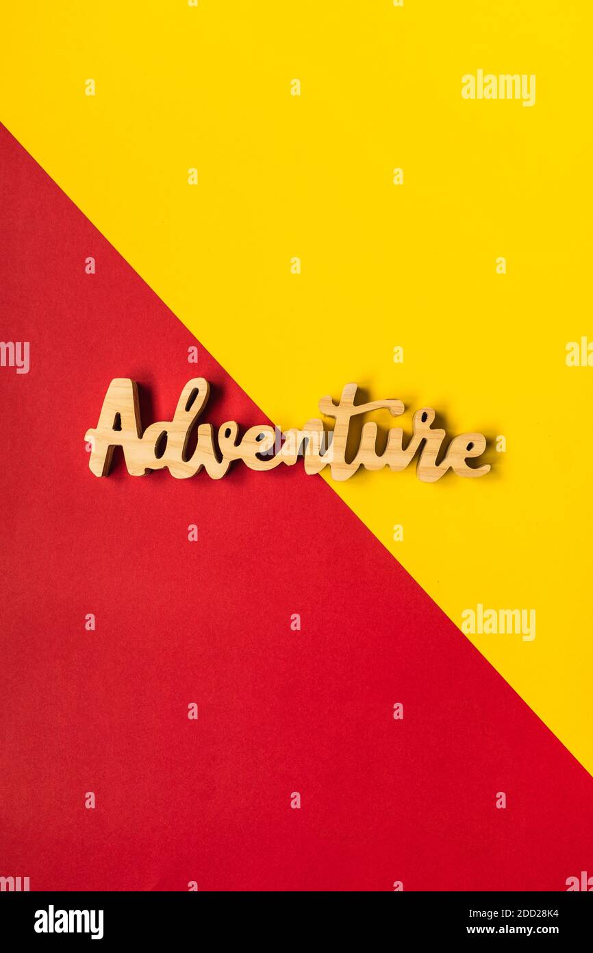 Background made of two colors, yellow and red with adventure wood text ...