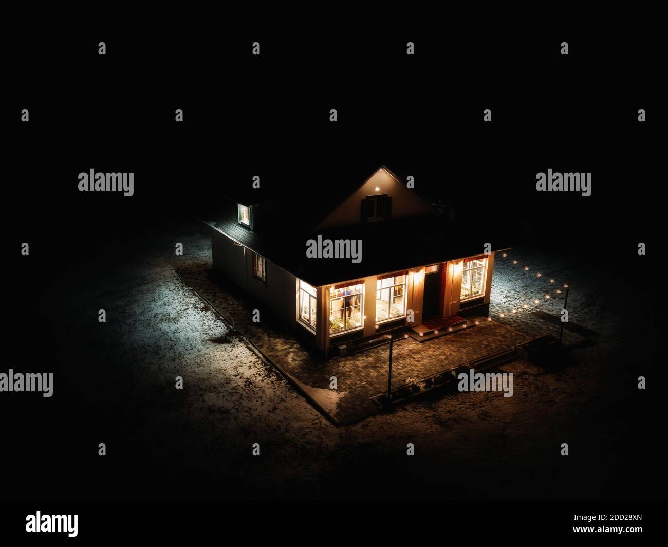 Lonely illuminated house among darkness, aerial view. Loneliness and ...