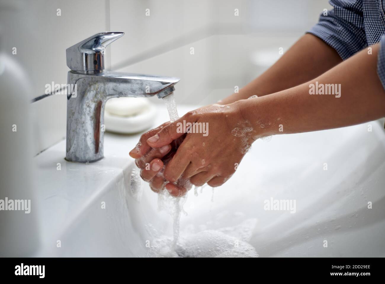 Hand washing rinsing off soap with water. Prevention of viral and ...
