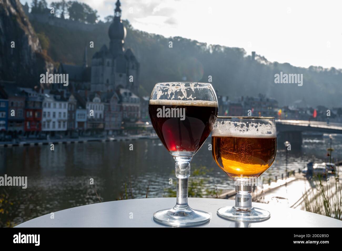 Drinking of dark and strong Belgian abbey beer with cheeses in sunny ...