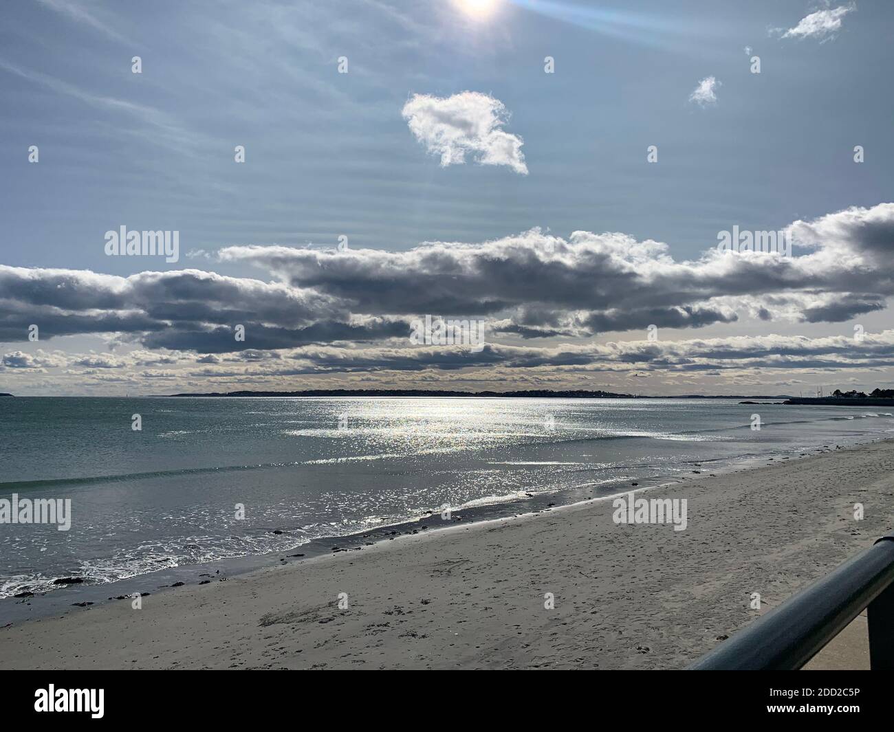 sun shine on calm sea under a sky with clouds Stock Photo - Alamy